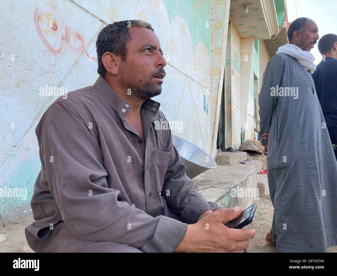 Ashraf Sadawy Abdel-Fattah sits outside his home in the farming village ...