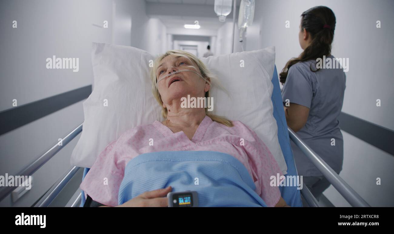 Young nurse transports elderly woman hi-res stock photography and ...