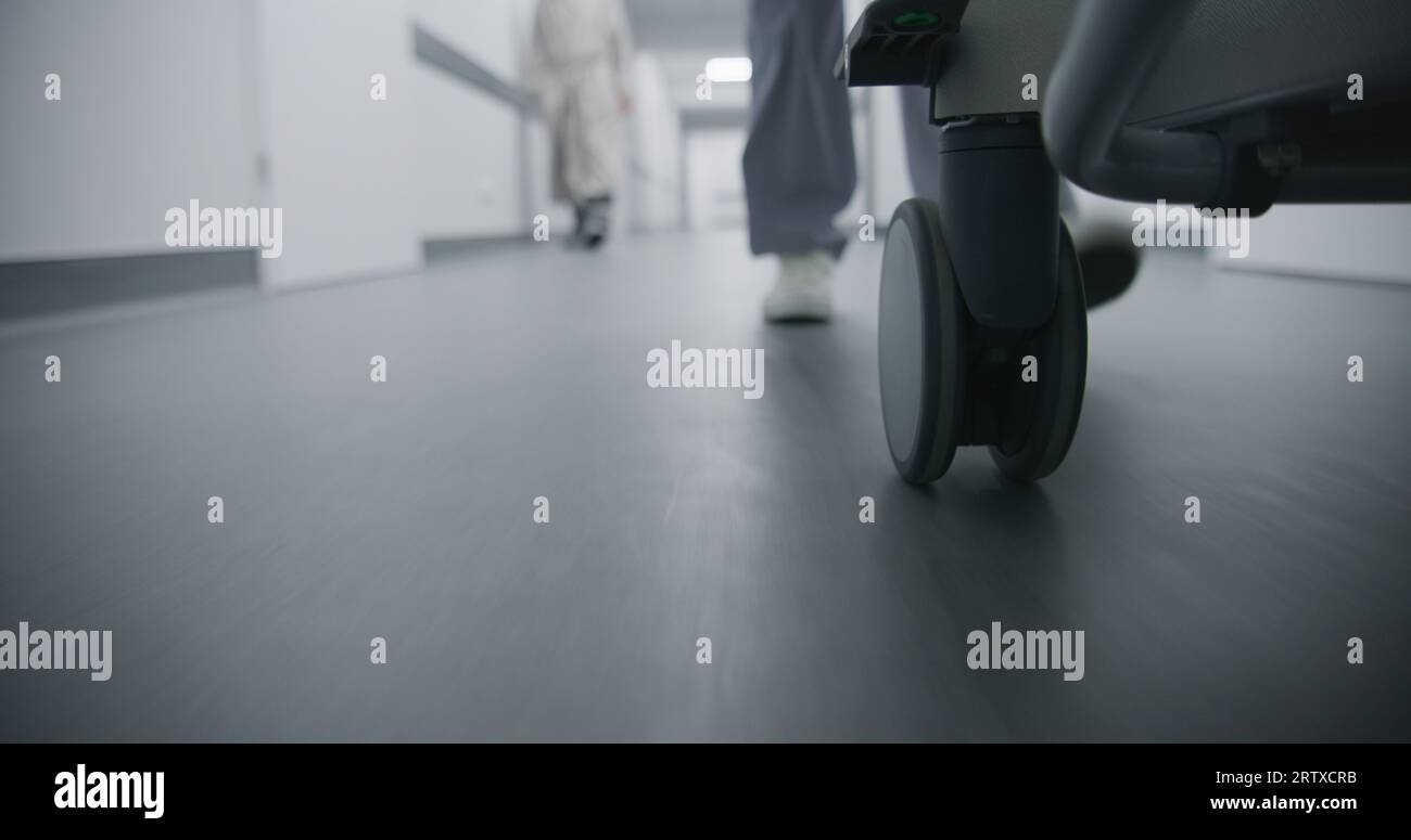 Doctor, nurse or paramedic move gurney with seriously injured patient ...