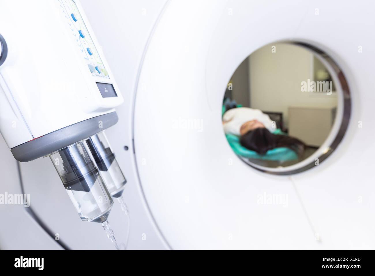 Pretty, young woman goiing through a Computerized Axial Tomography CAT ...