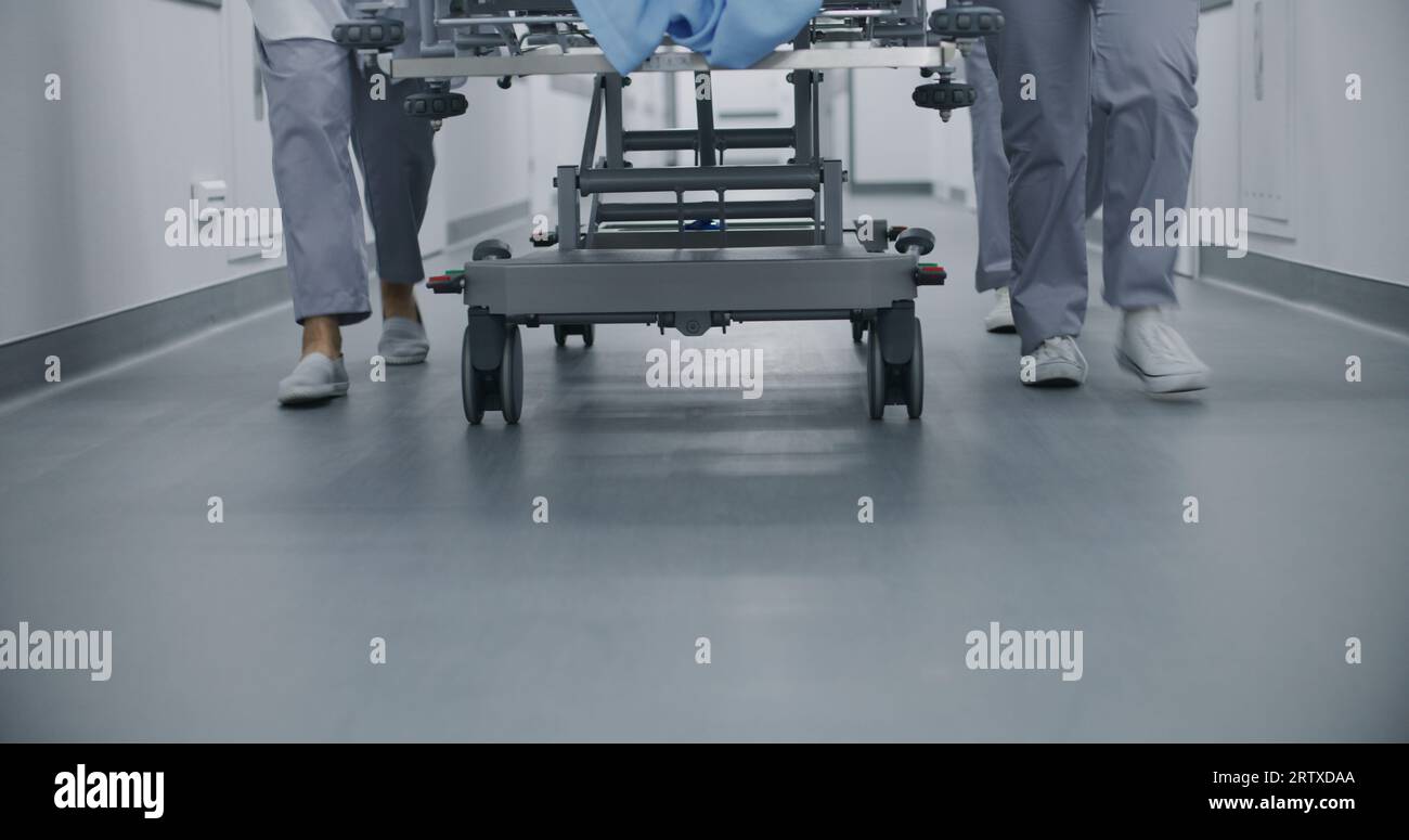 Doctors and nurses push stretcher with seriously injured patient ...