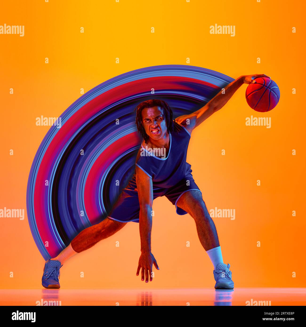 Muscular young basketball player in motion, dribbling over orange ...