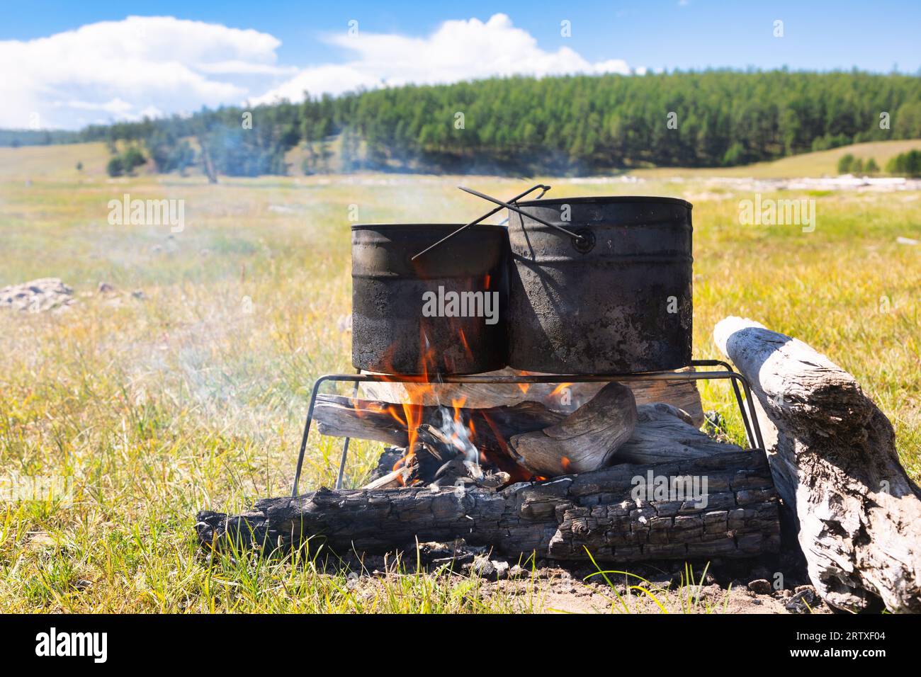 Pots cooking food on campfire hi-res stock photography and images - Alamy