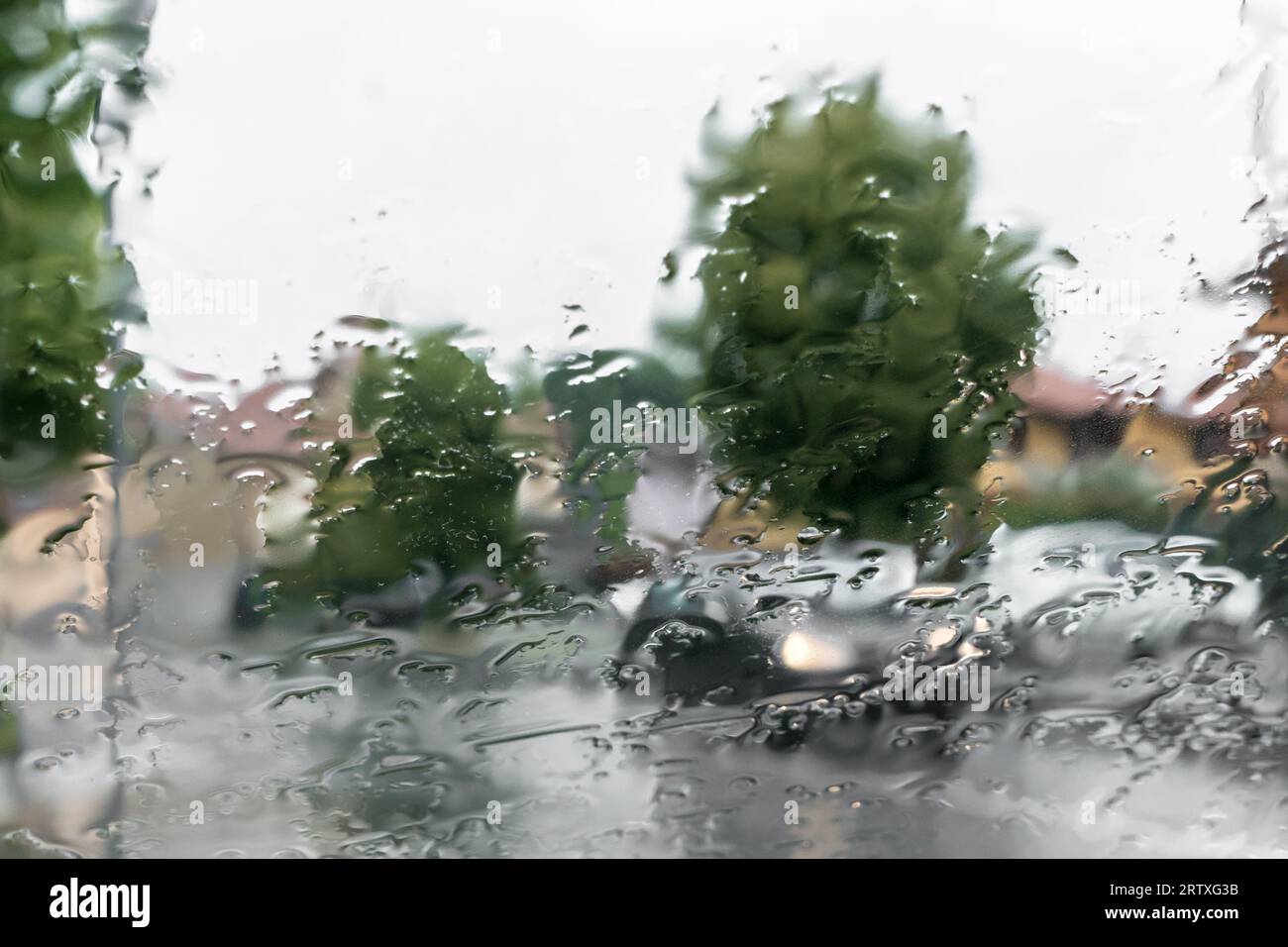 Blurred view of road through wet car window. Rainy weather. Safety ...