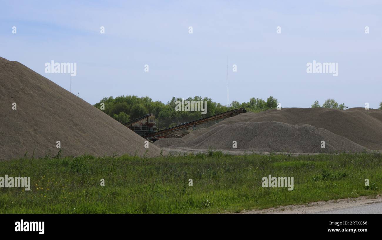 digging stone out of the ground using an industrial method, mountains ...