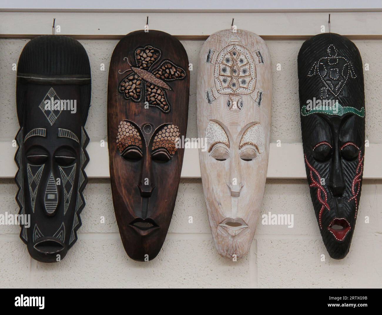 Four Different Wooden Ethnic Masks Hanging on Display Stock Photo - Alamy