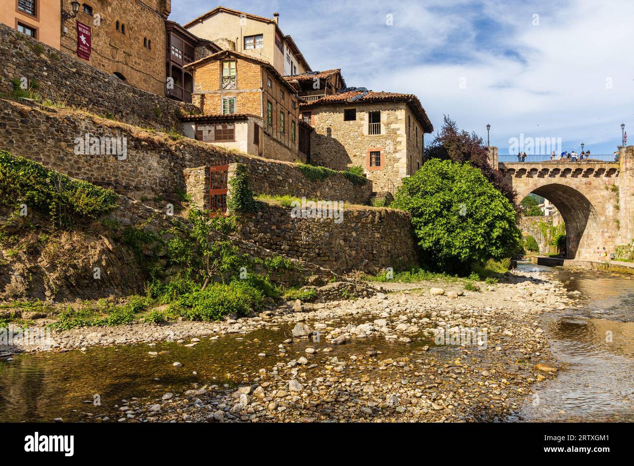 View of medieval building of Potes old town, Quivies river and San ...