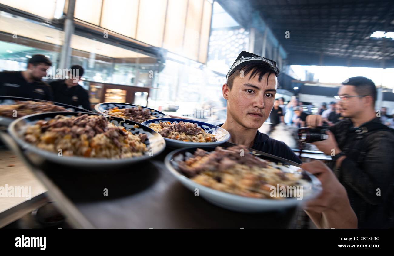 Tashkent, Uzbekistan. 14th Sep, 2023. A staff member carries a tray of ...
