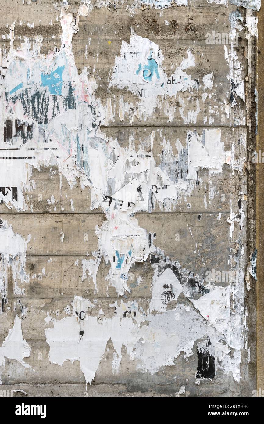 Concrete wall with colorful ripped bill posters. Grunge background ...