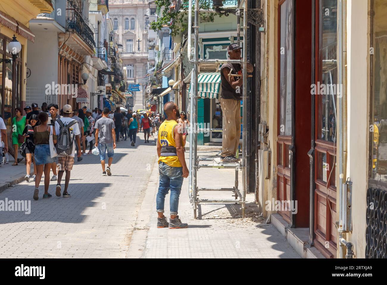 Havana, Cuba, 2023, Two construction workers in a scaffolding. They are ...