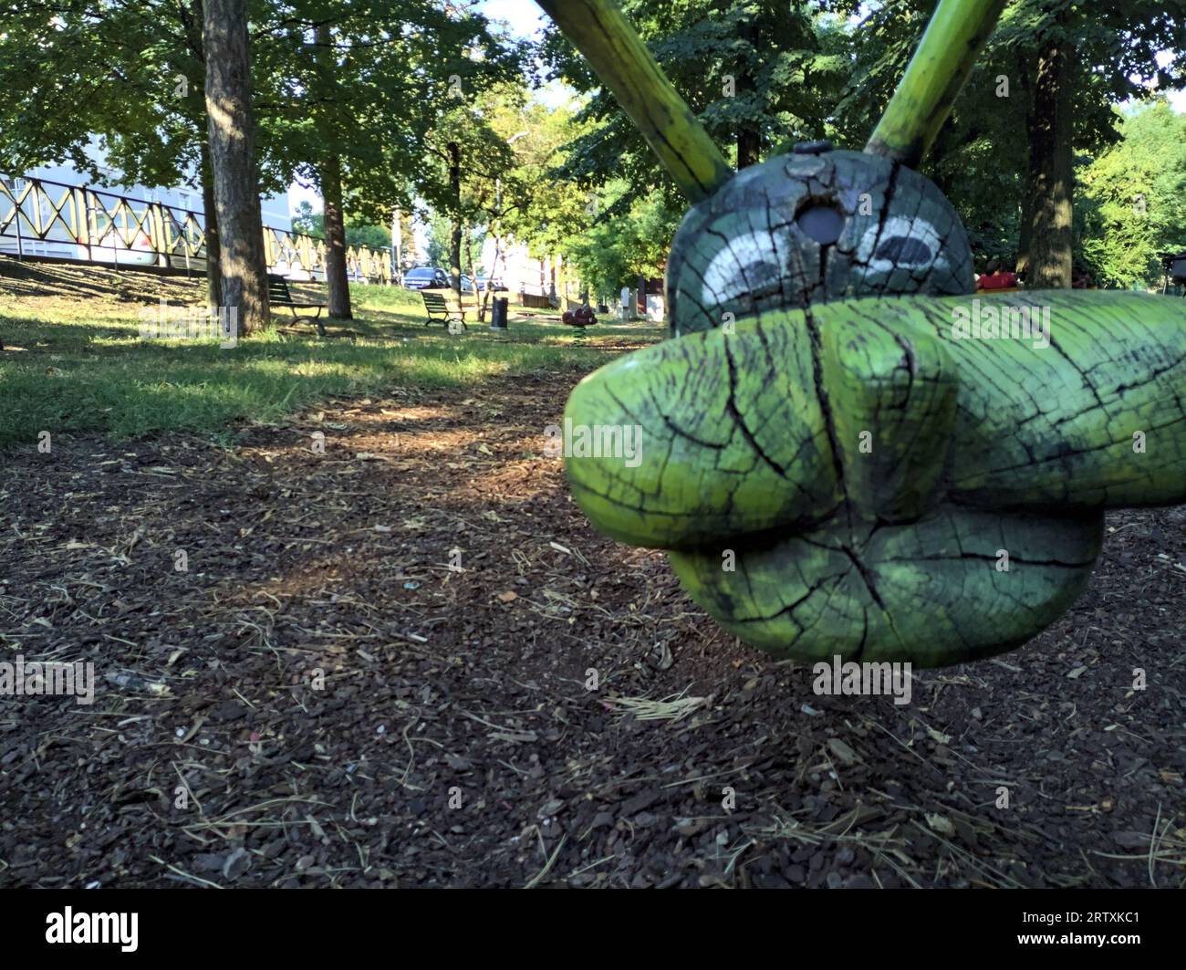 Ride shaped as a caterpillar in a playground of a park on a sunny day ...