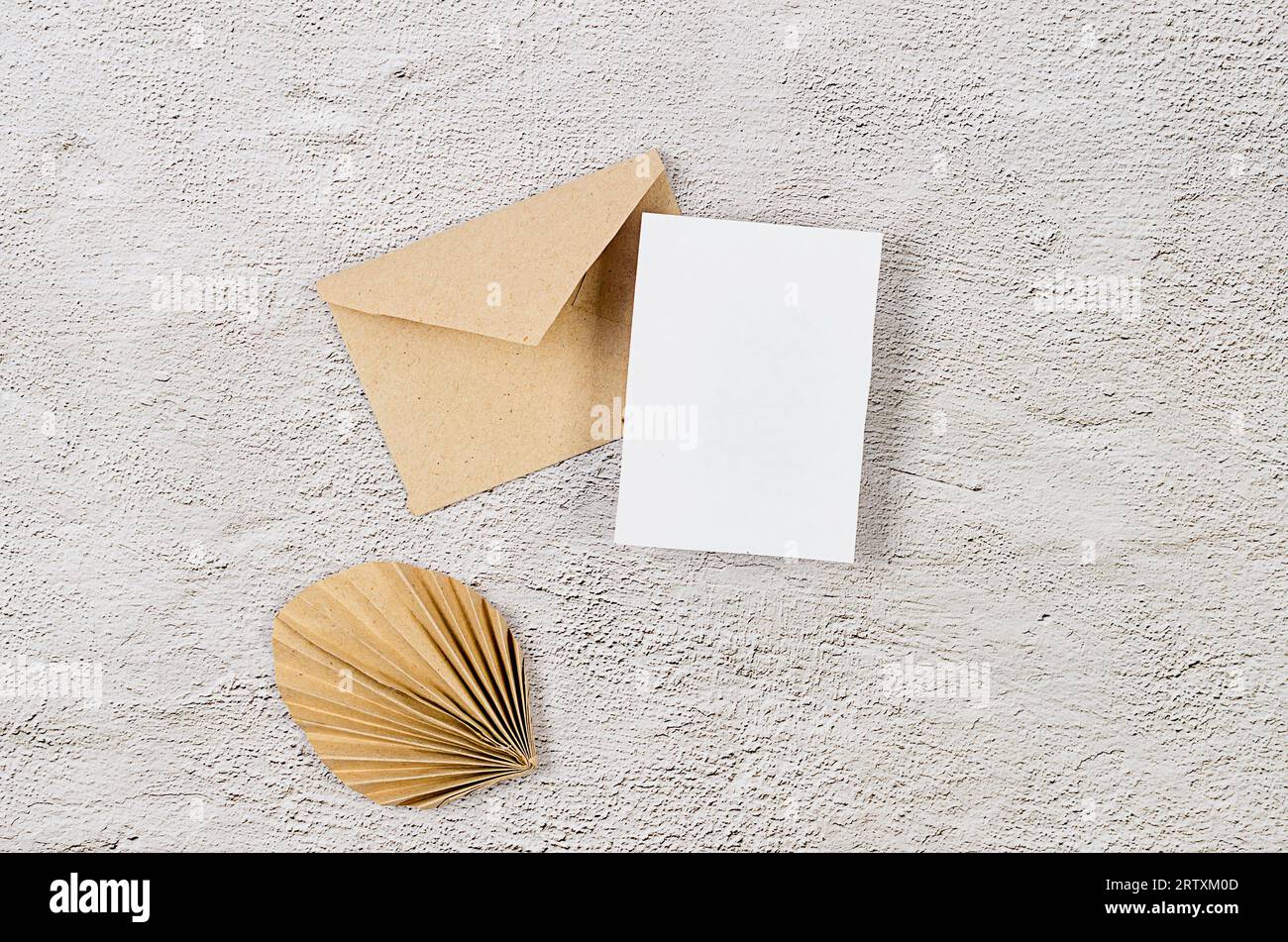 brown kraft paper envelope with empty white card for text on grey ...