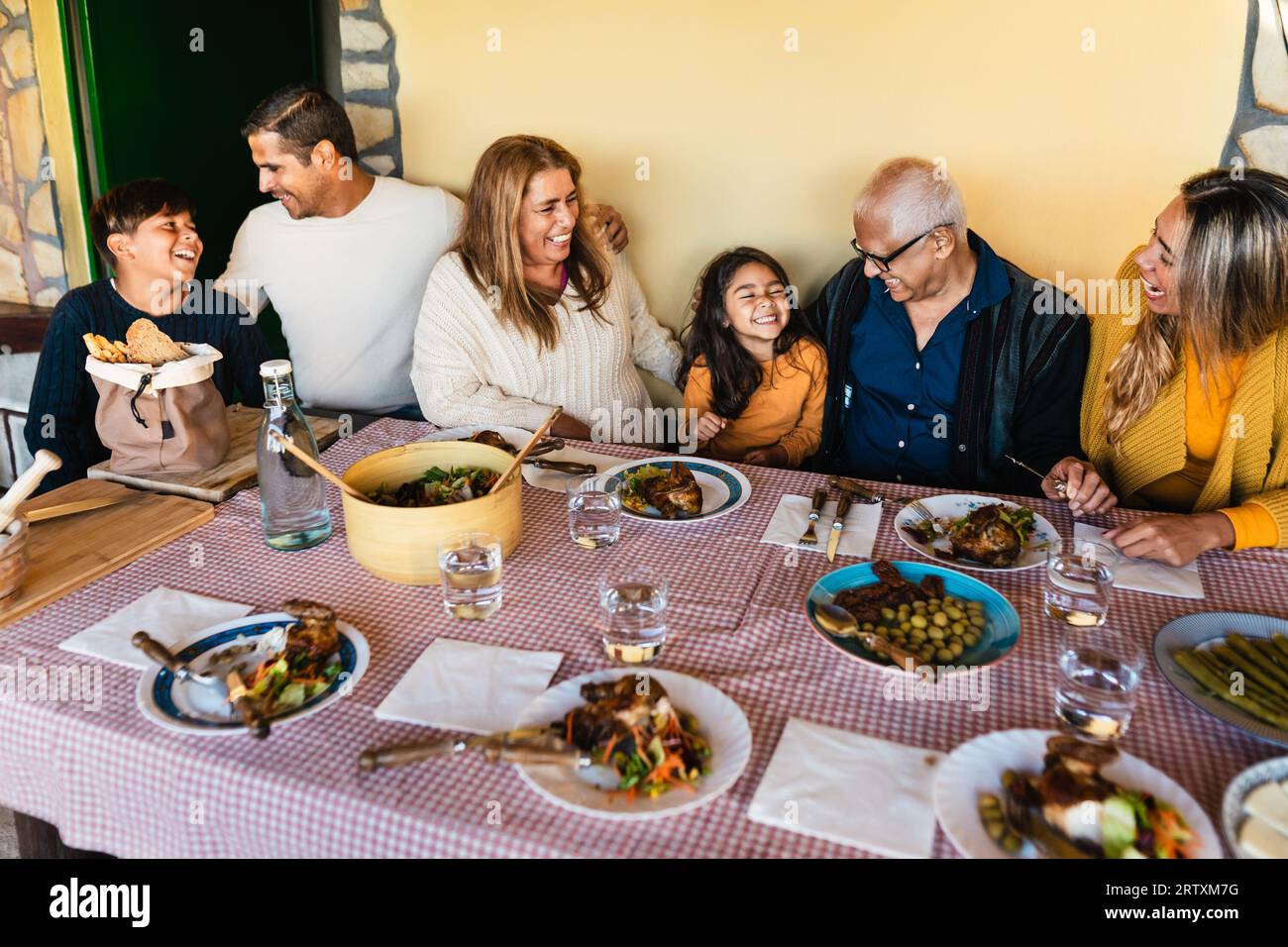 Happy Latin family having fun lunching together at home Stock Photo - Alamy