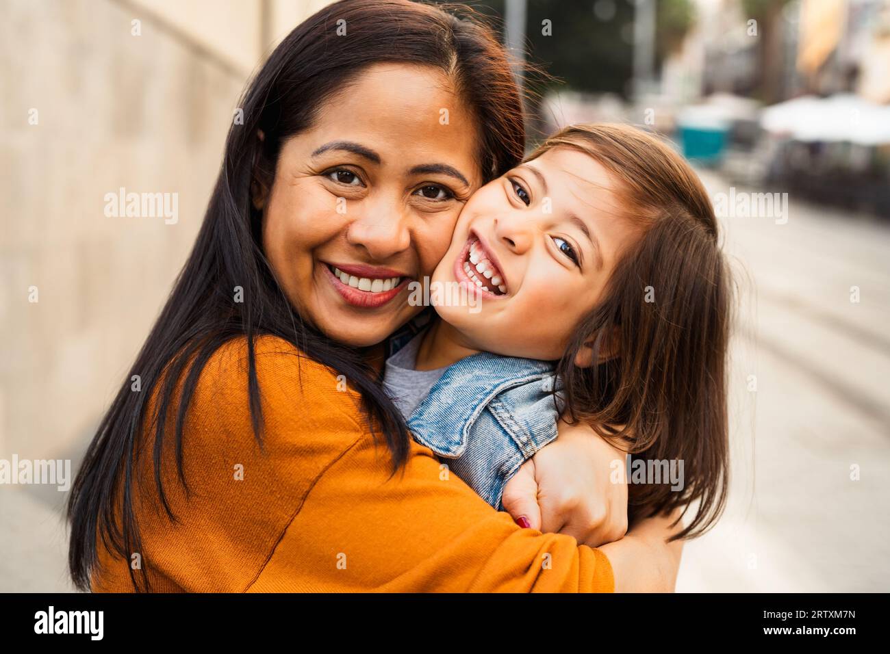 Happy Southeast Asian Mother With Her Daughter Having Fun In The City