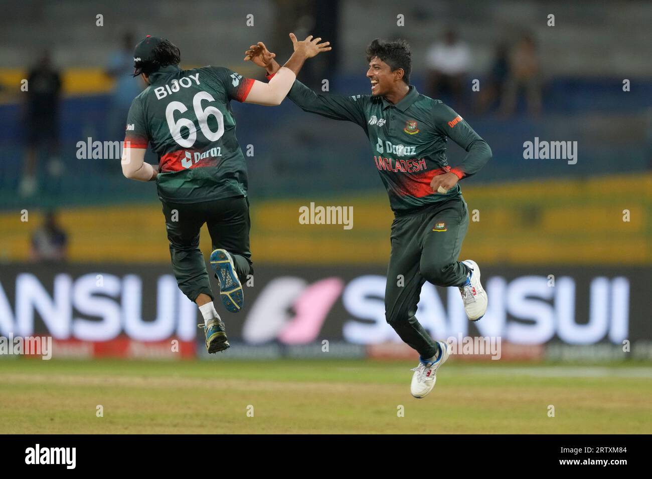 Bangladesh's Mahedi Hasan, right, celebrates taking the wicket of India ...