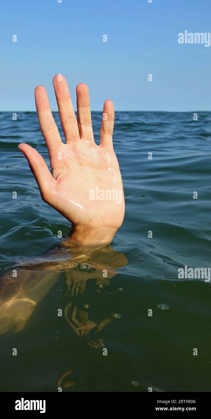 five fingers of the hand of the person who is drowning in the ocean and ...