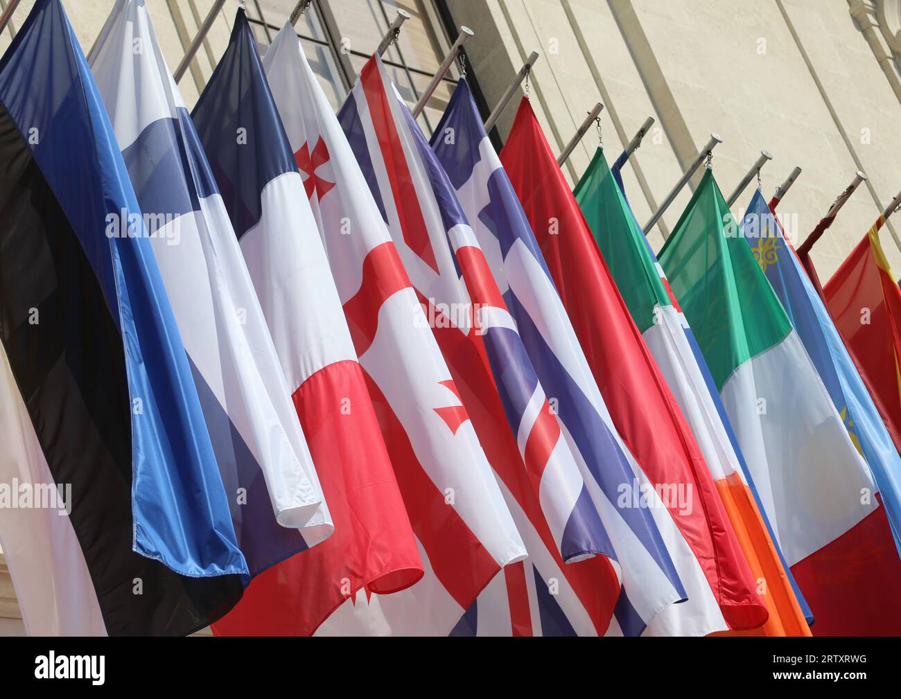 colorful flags of many world nations hanging outside government ...