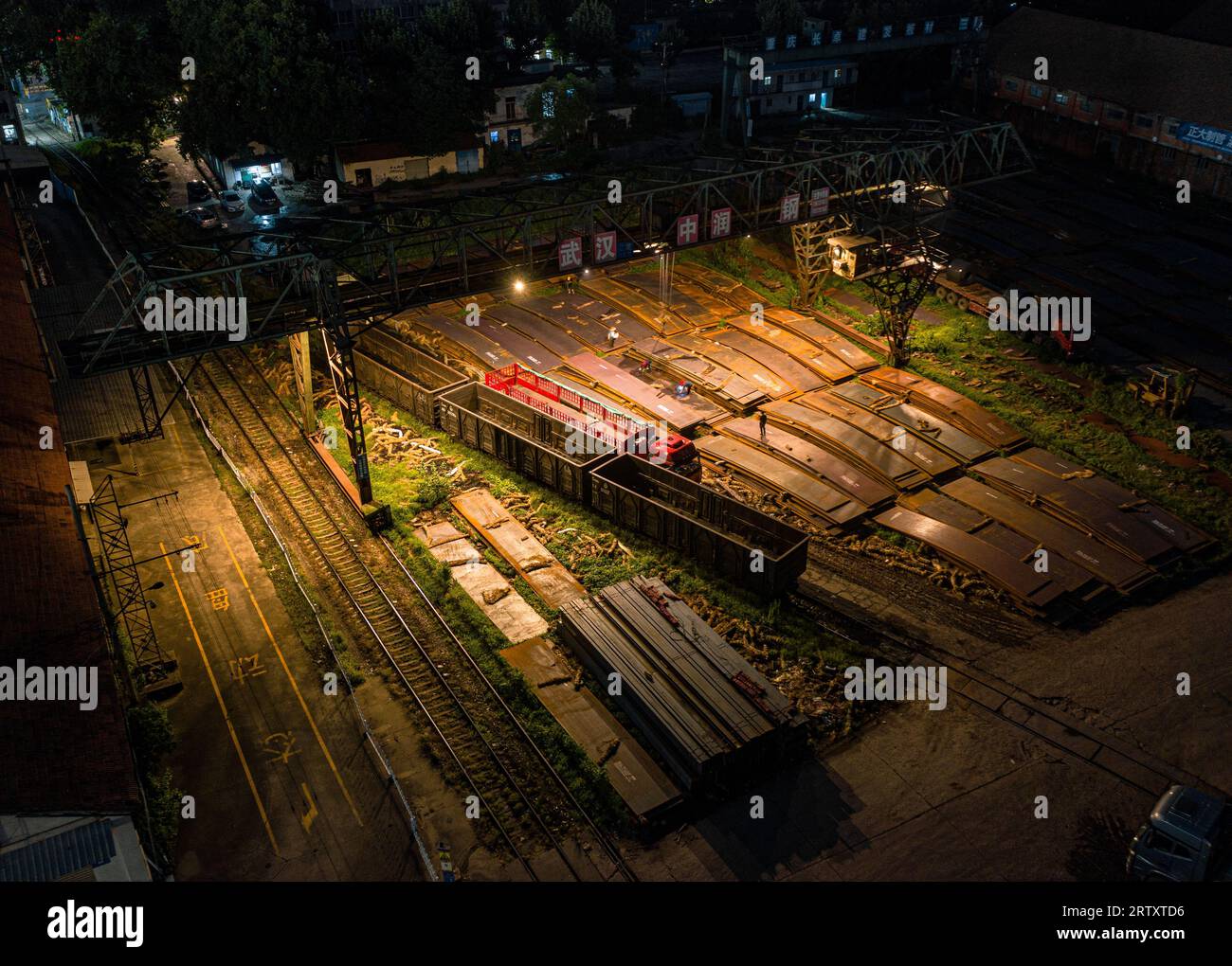 An aerial view of a bustling train yard under construction surrounded ...