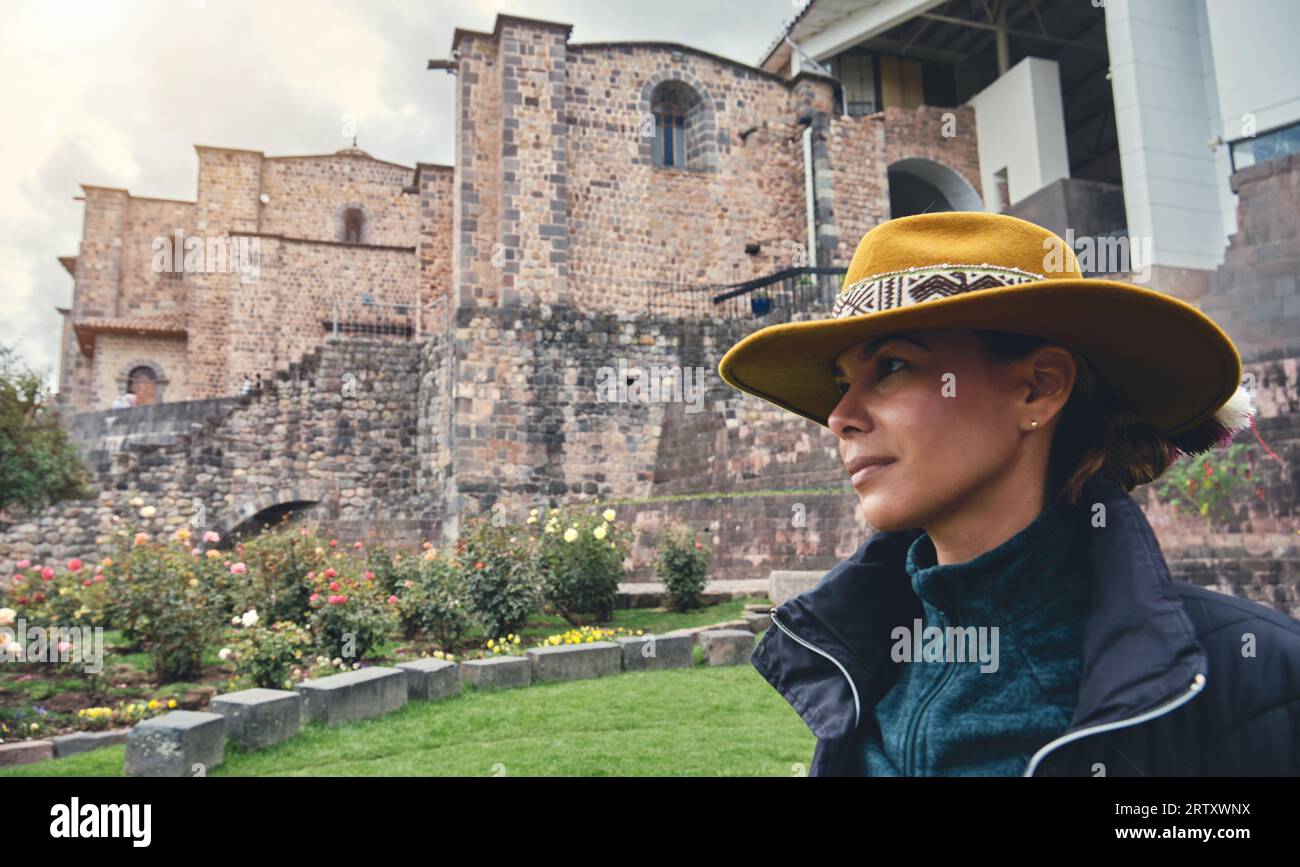Exploring Qorikancha Inner Gardens. Beautiful Tourist with Hat in Cusco ...