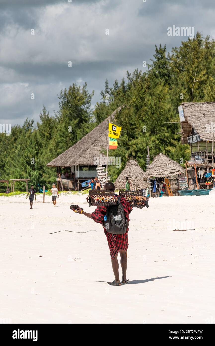 Maasai shoe seller on the white sands of Zanzibar Stock Photo - Alamy