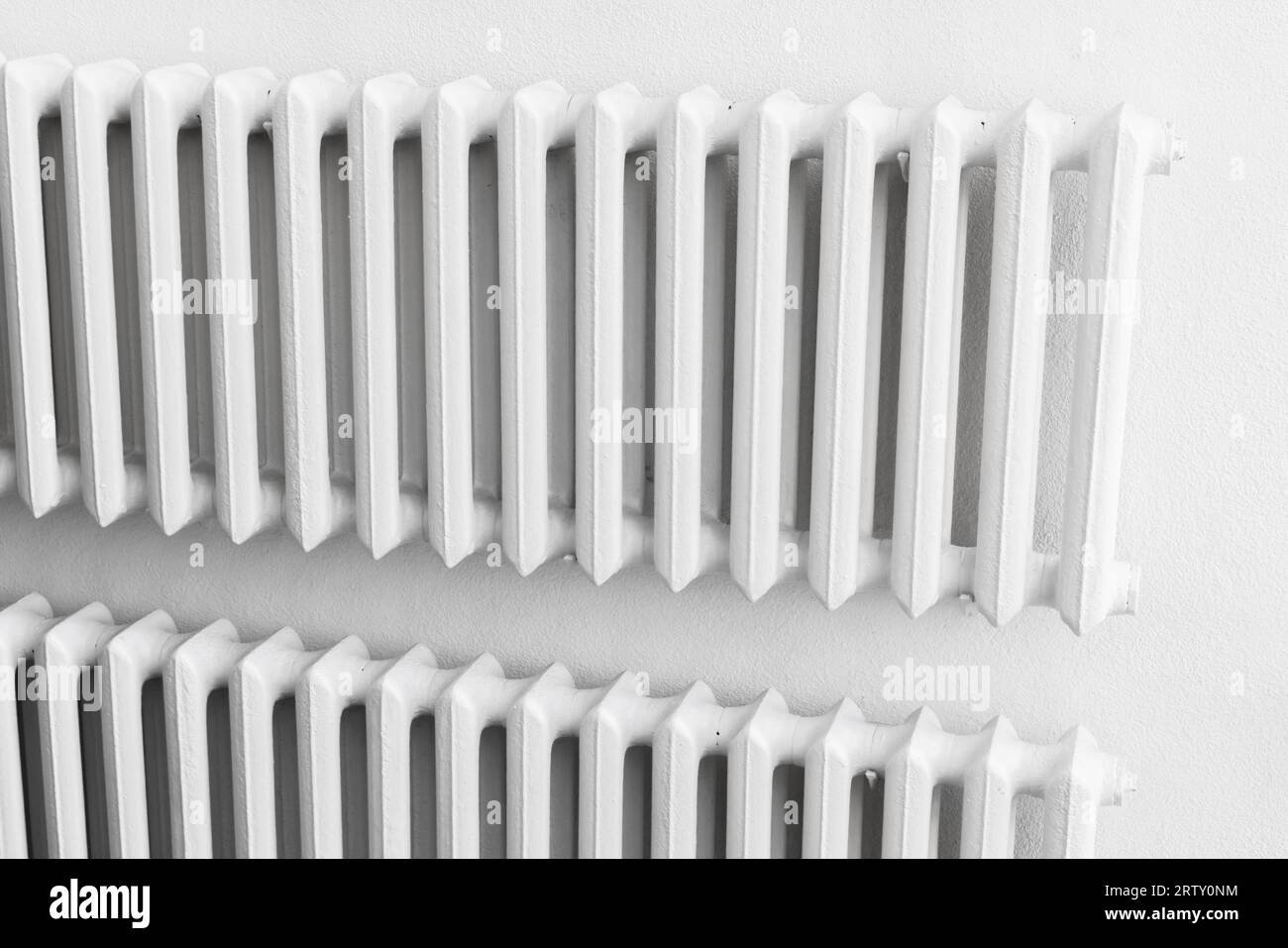 White radiators mounted on the wall. Classic urban house heating ...