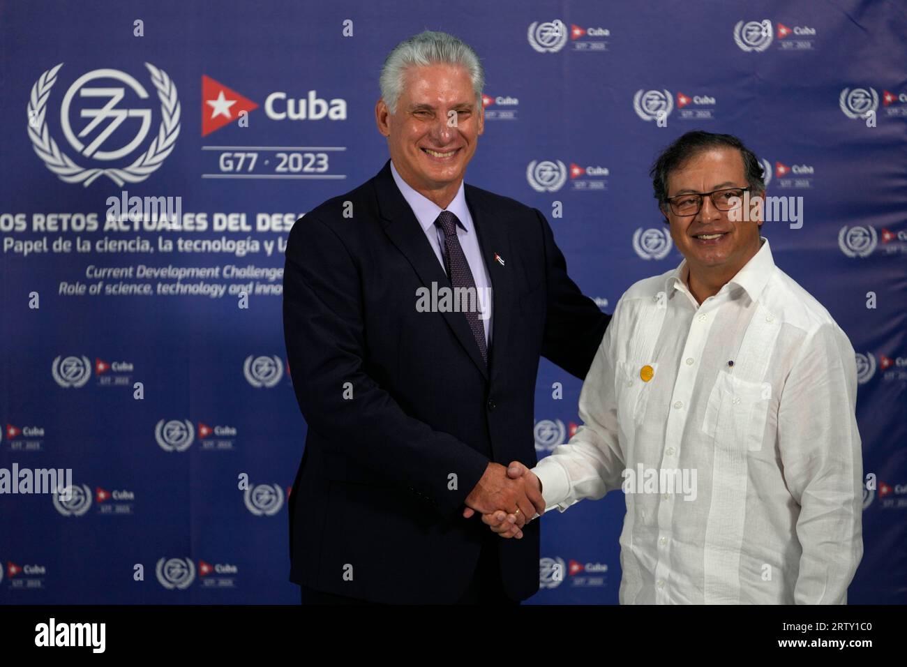 Cuban President Miguel Diaz-Canel, left, shakes hands with Colombia's ...