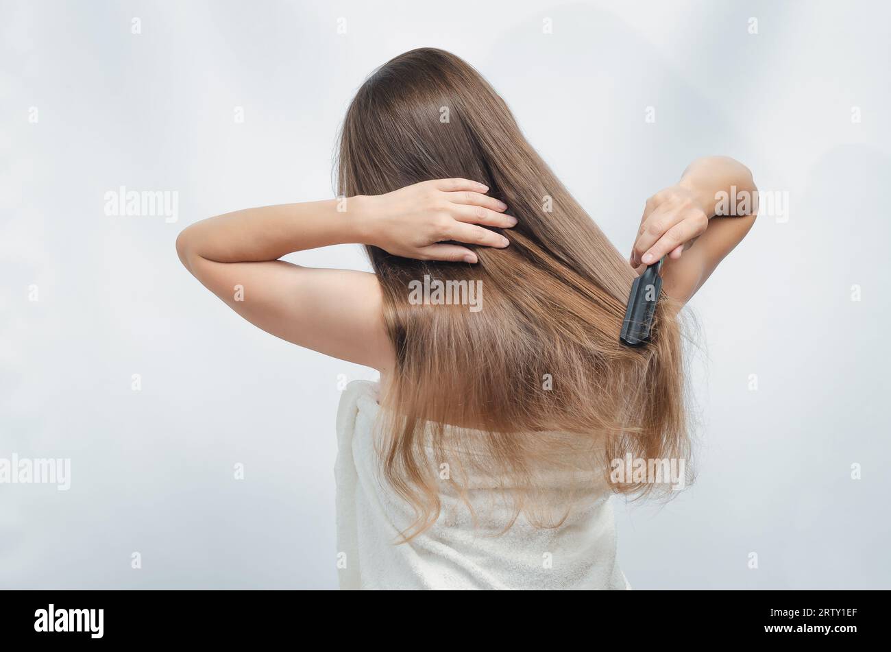 Beautiful woman combing hair hi-res stock photography and images - Alamy