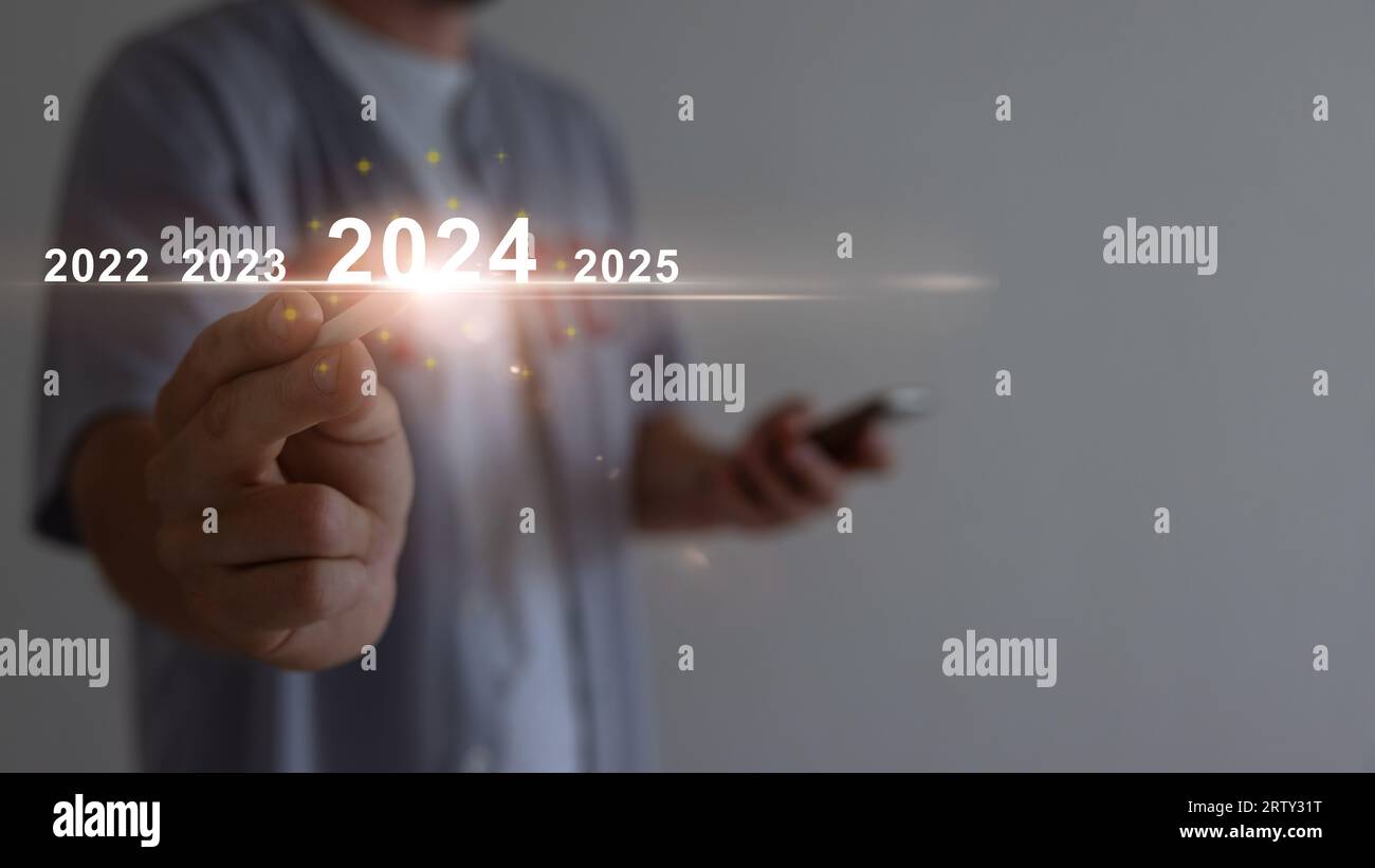 Man touching on virtual screen start button for 2024 New Year, Start ...