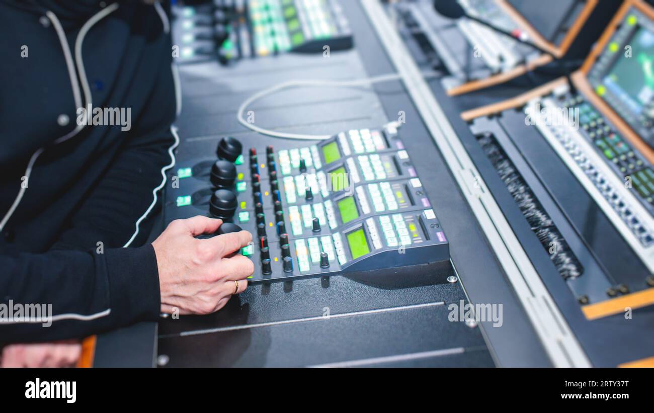 View of a lighting technician operator working on mixing console ...
