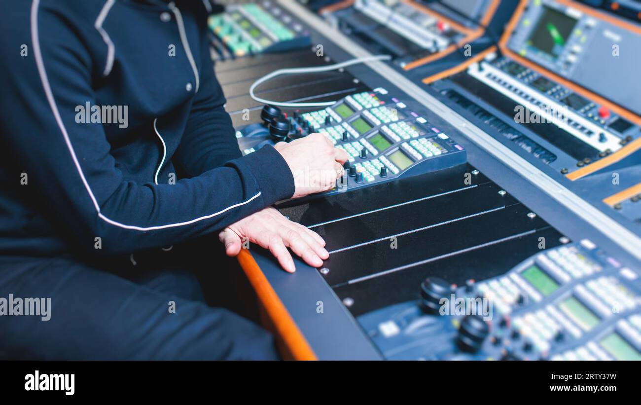 View of a lighting technician operator working on mixing console ...