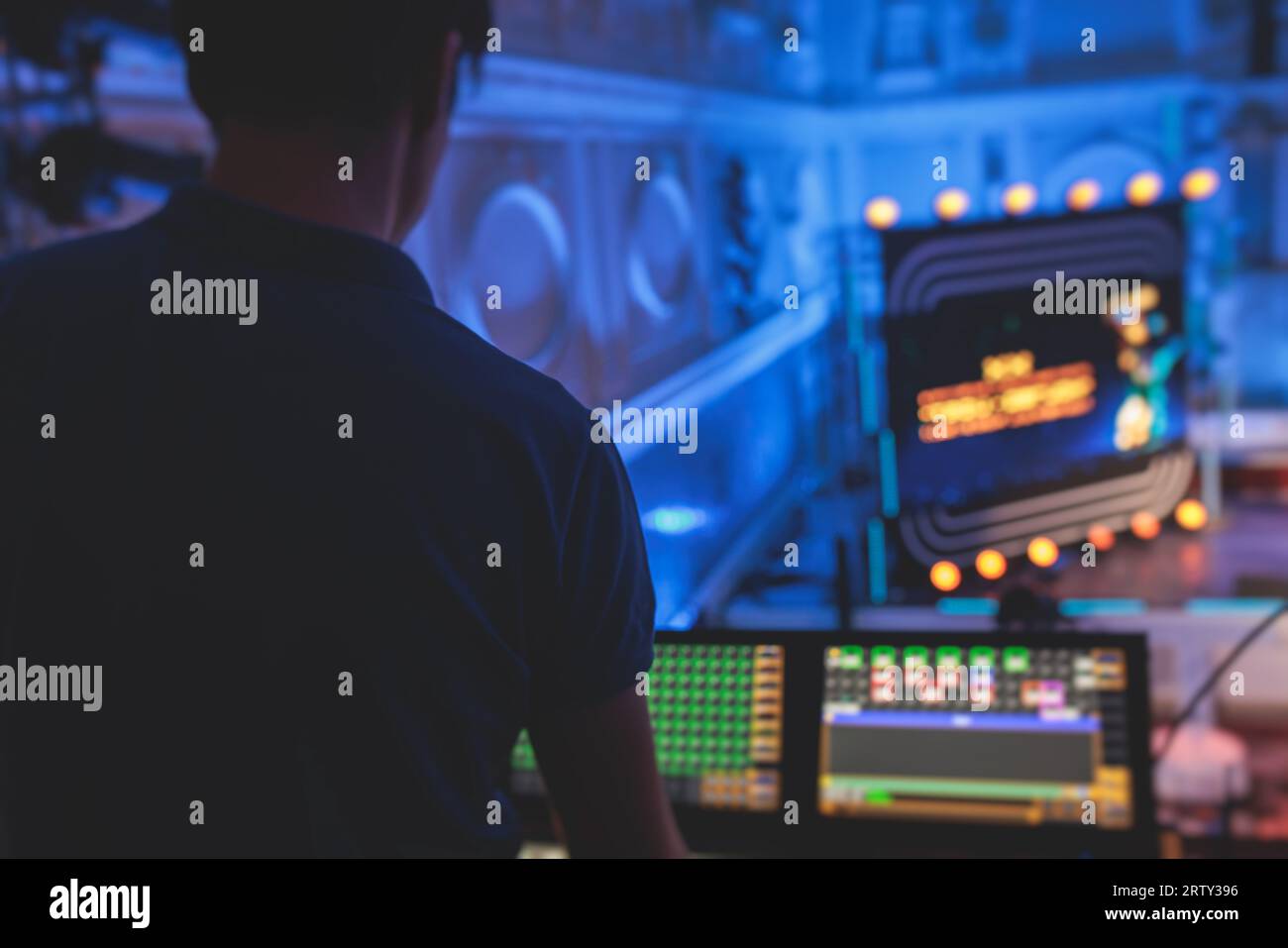 View of a lighting technician operator working on mixing console ...