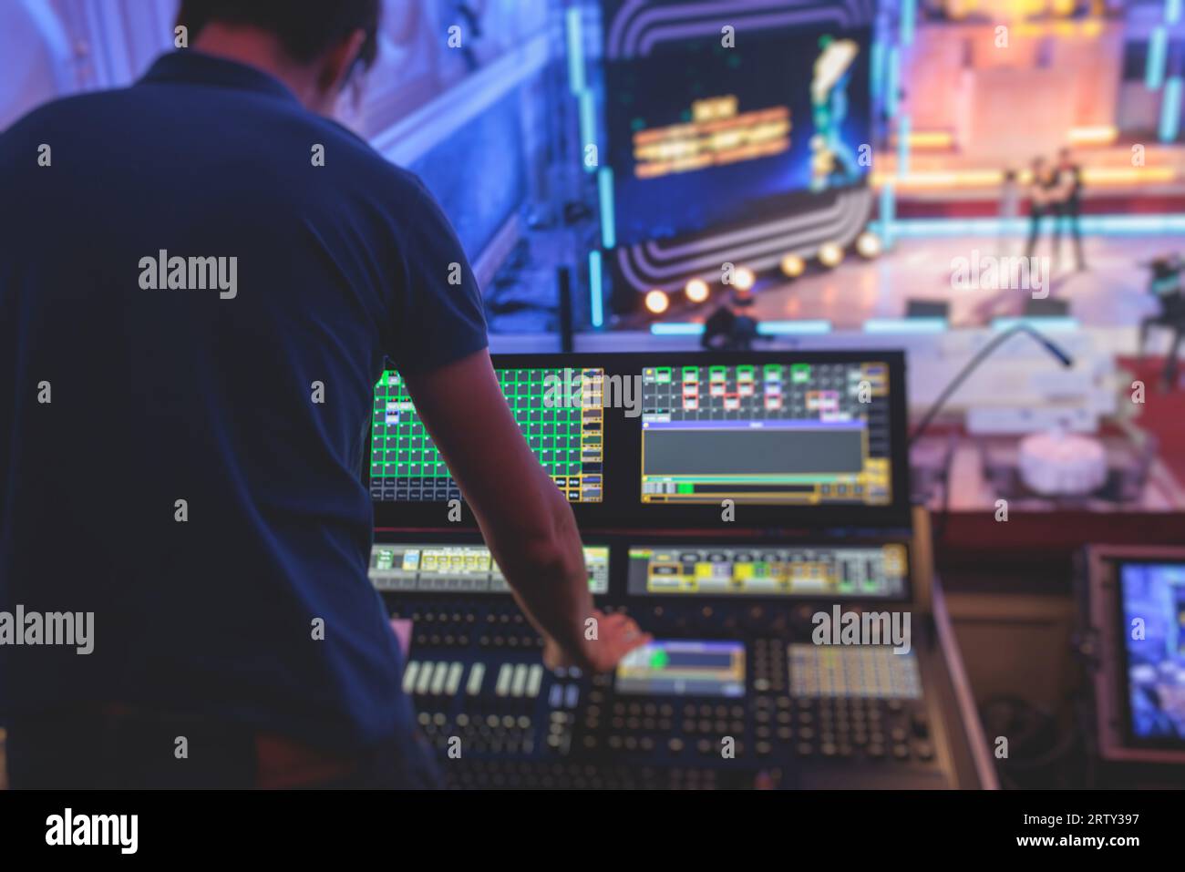 View of a lighting technician operator working on mixing console ...