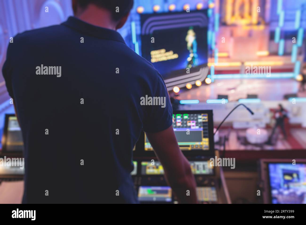 View of a lighting technician operator working on mixing console ...