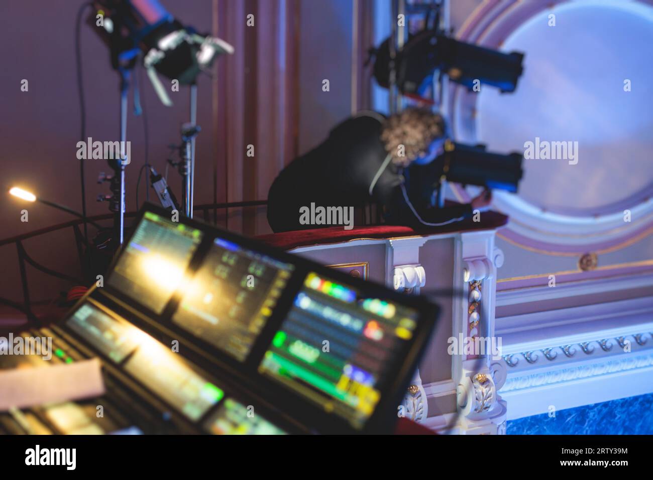 Stage worker assistant sets up lights, light engineer, lighting ...