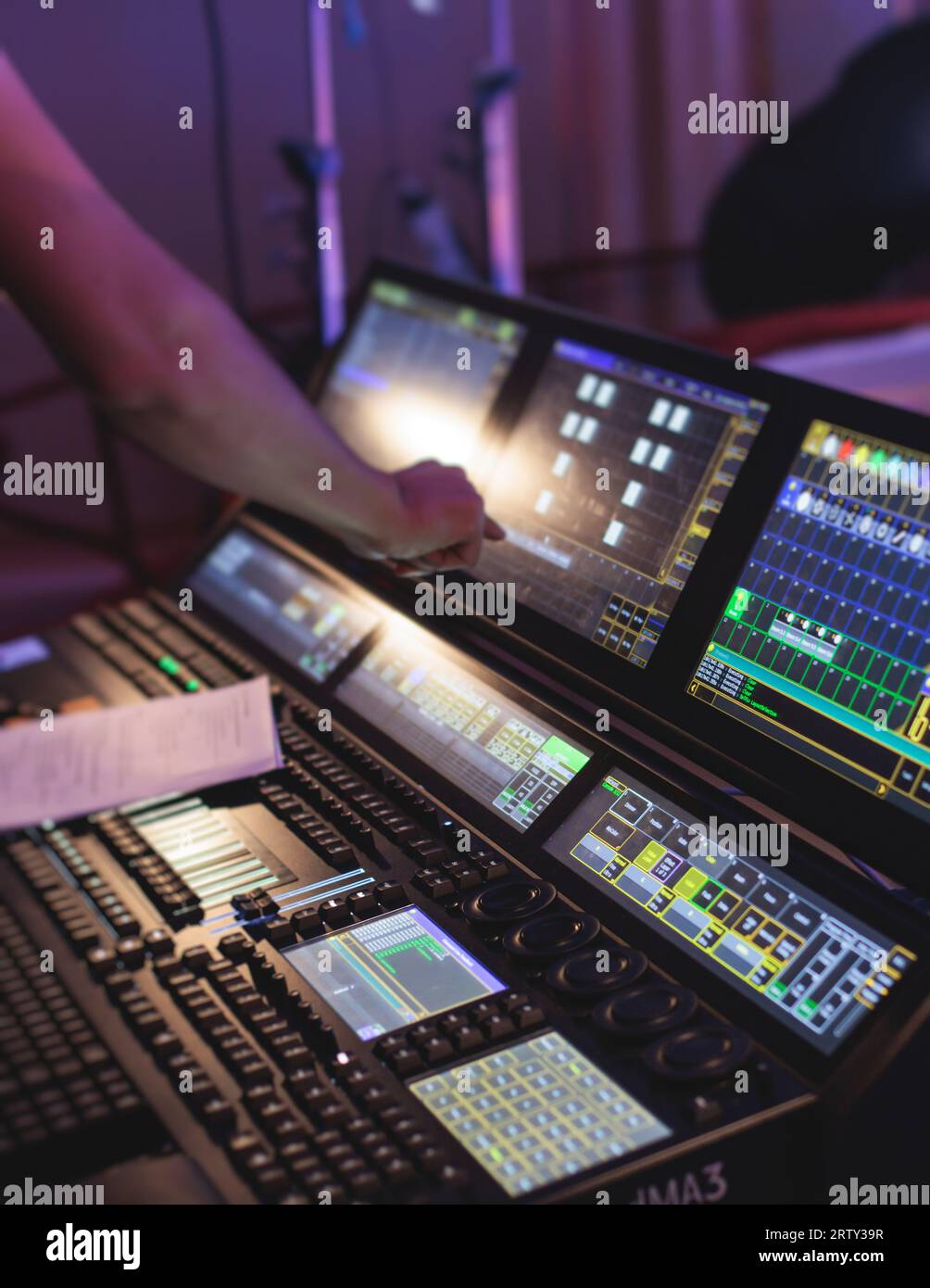View of a lighting technician operator working on mixing console ...