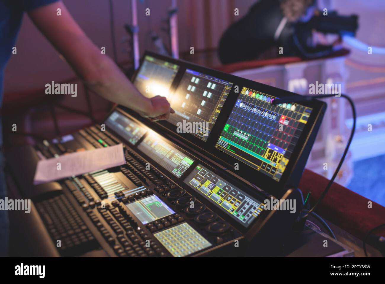 View of a lighting technician operator working on mixing console ...