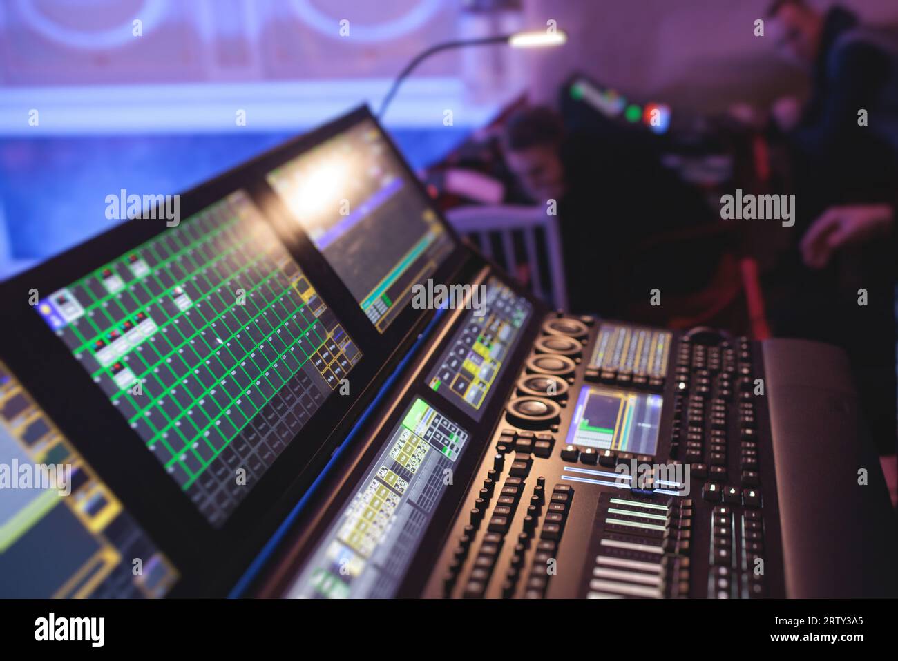 View of a lighting technician operator working on mixing console ...