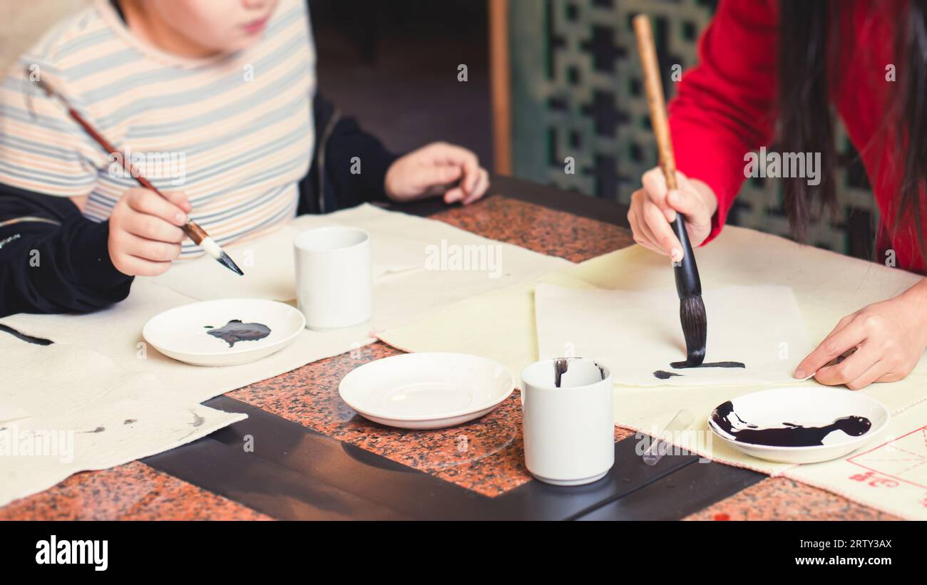 Chinese calligraphy lesson, group of kids learn and practicing ... Chinese calligraphy lesson, group of kids learn and practicing ...