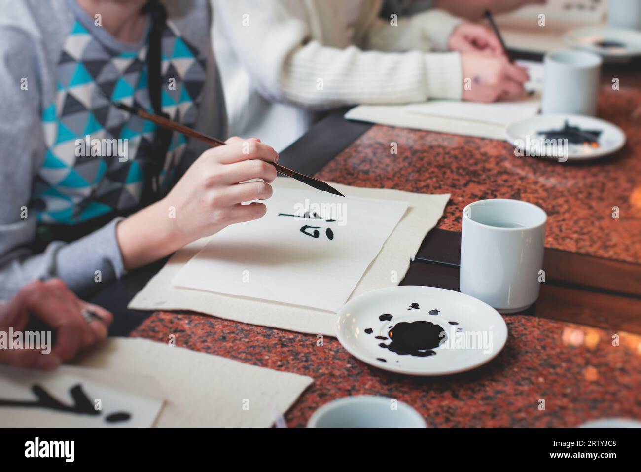 Chinese calligraphy lesson, group of kids learn and practicing ... Chinese calligraphy lesson, group of kids learn and practicing ...