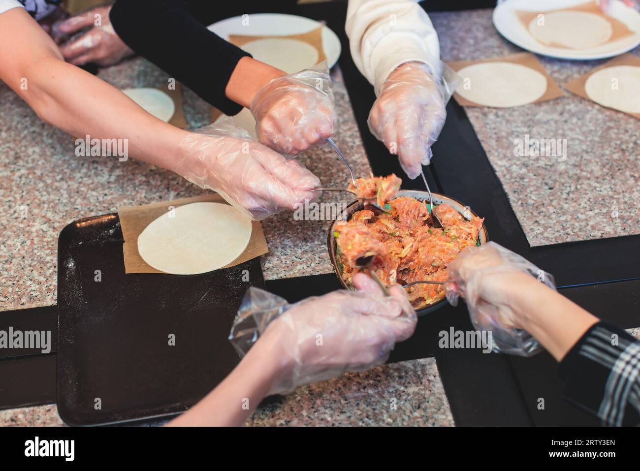 Group of children in a cooking class, kids preparing asian style food ...