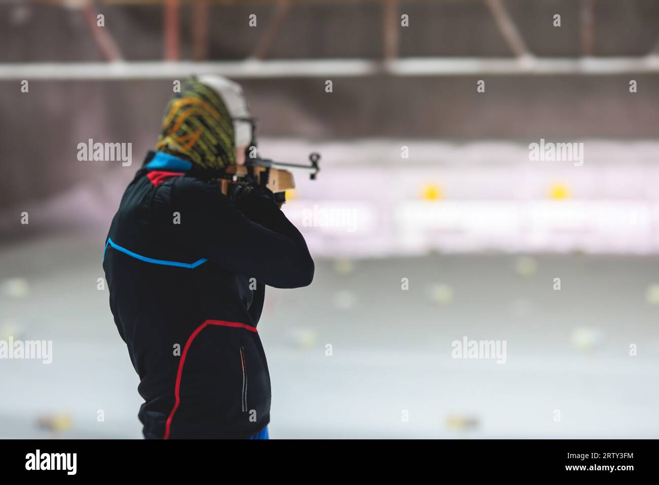 Biathlete with rifle on a shooting range during biathlon training ...
