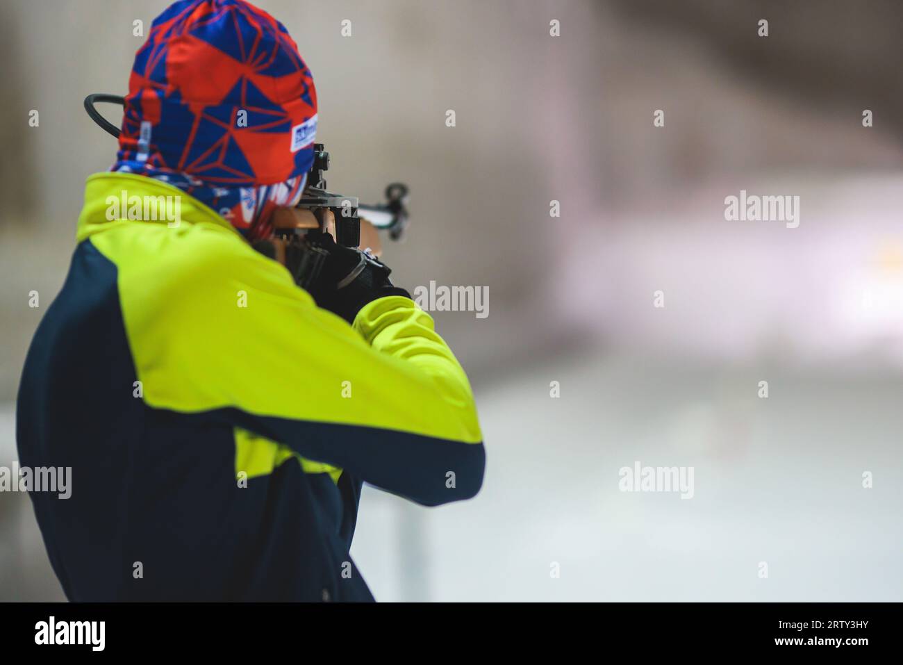 Biathlete with rifle on a shooting range during biathlon training ...