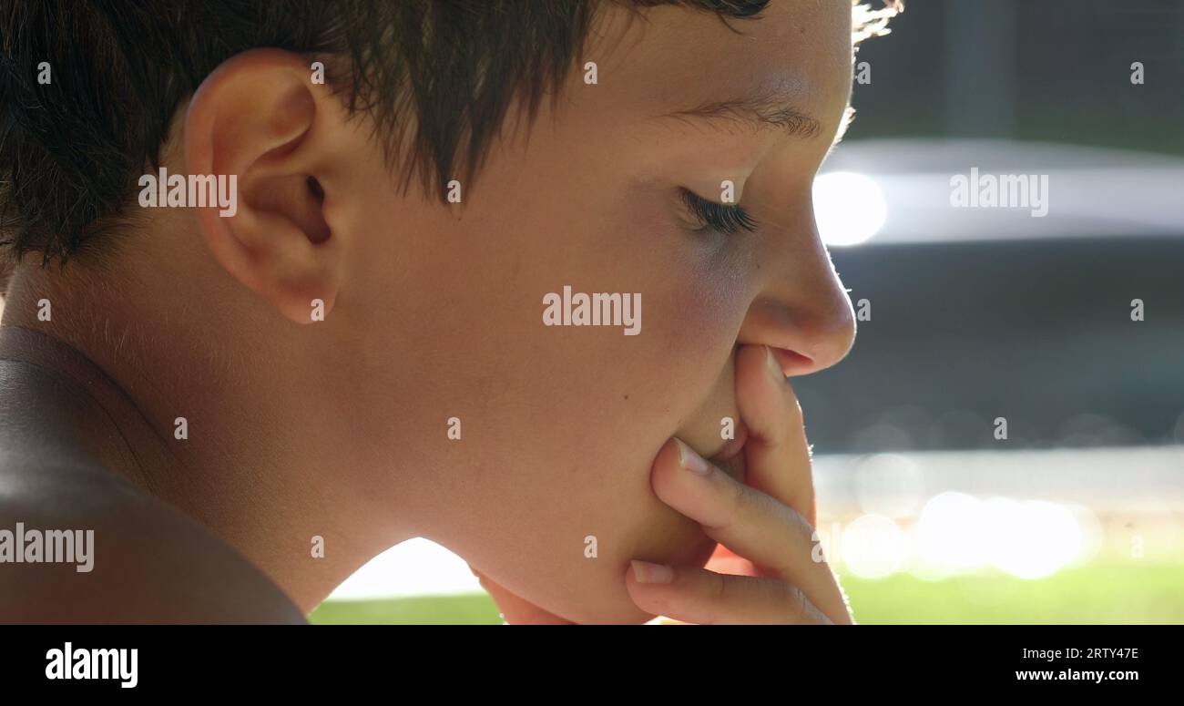 Contemplative child boy pondering solution to decision making. Pensive ...