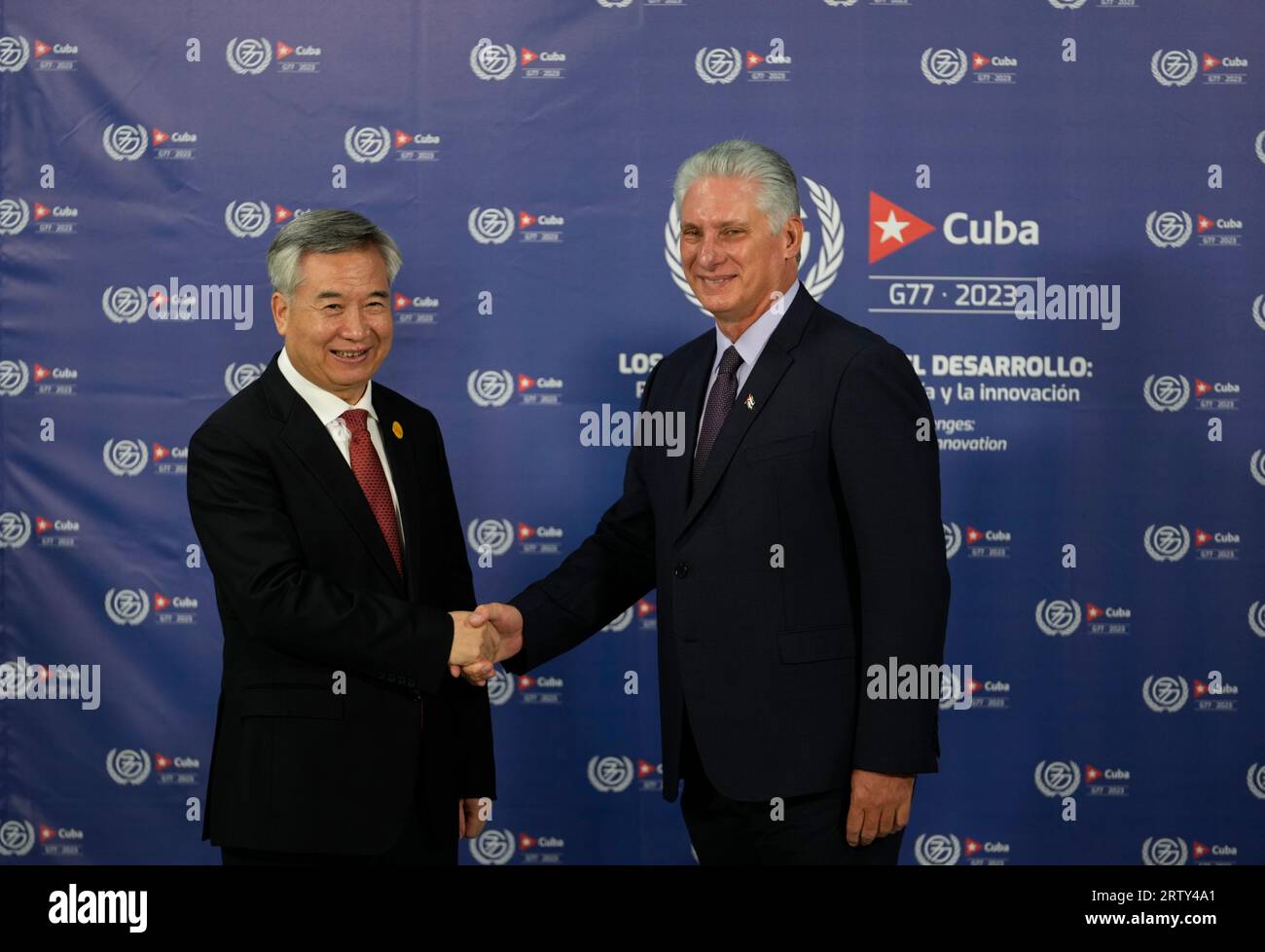 Cuban President Miguel Diaz-Canel, right, shakes hands with Li Xi ...