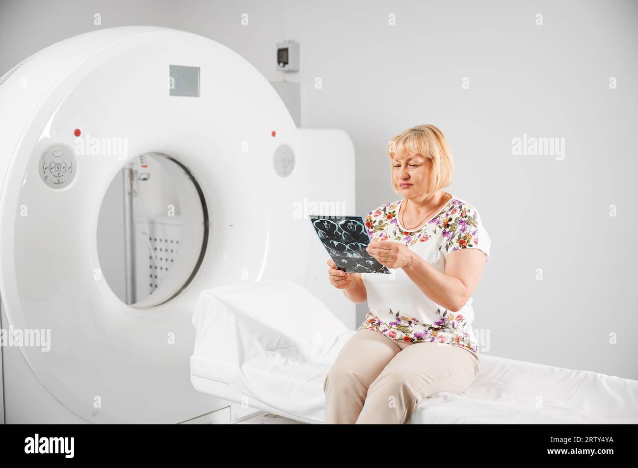 Medical computed tomography or MRI scanner. Patient making MRI, sitting ...