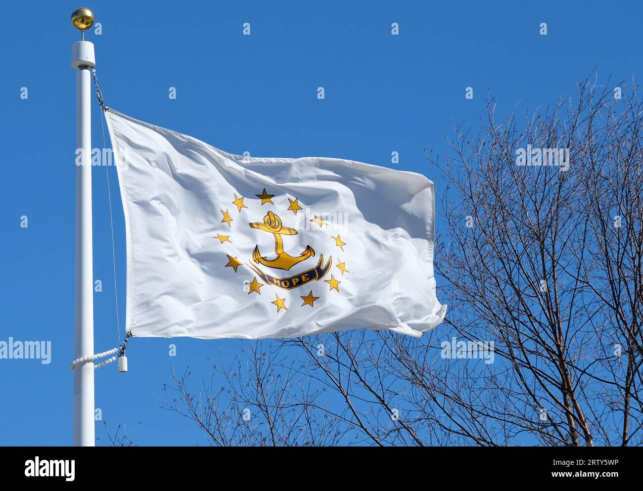 Close up of state flag against a blue sky background and white clouds ...