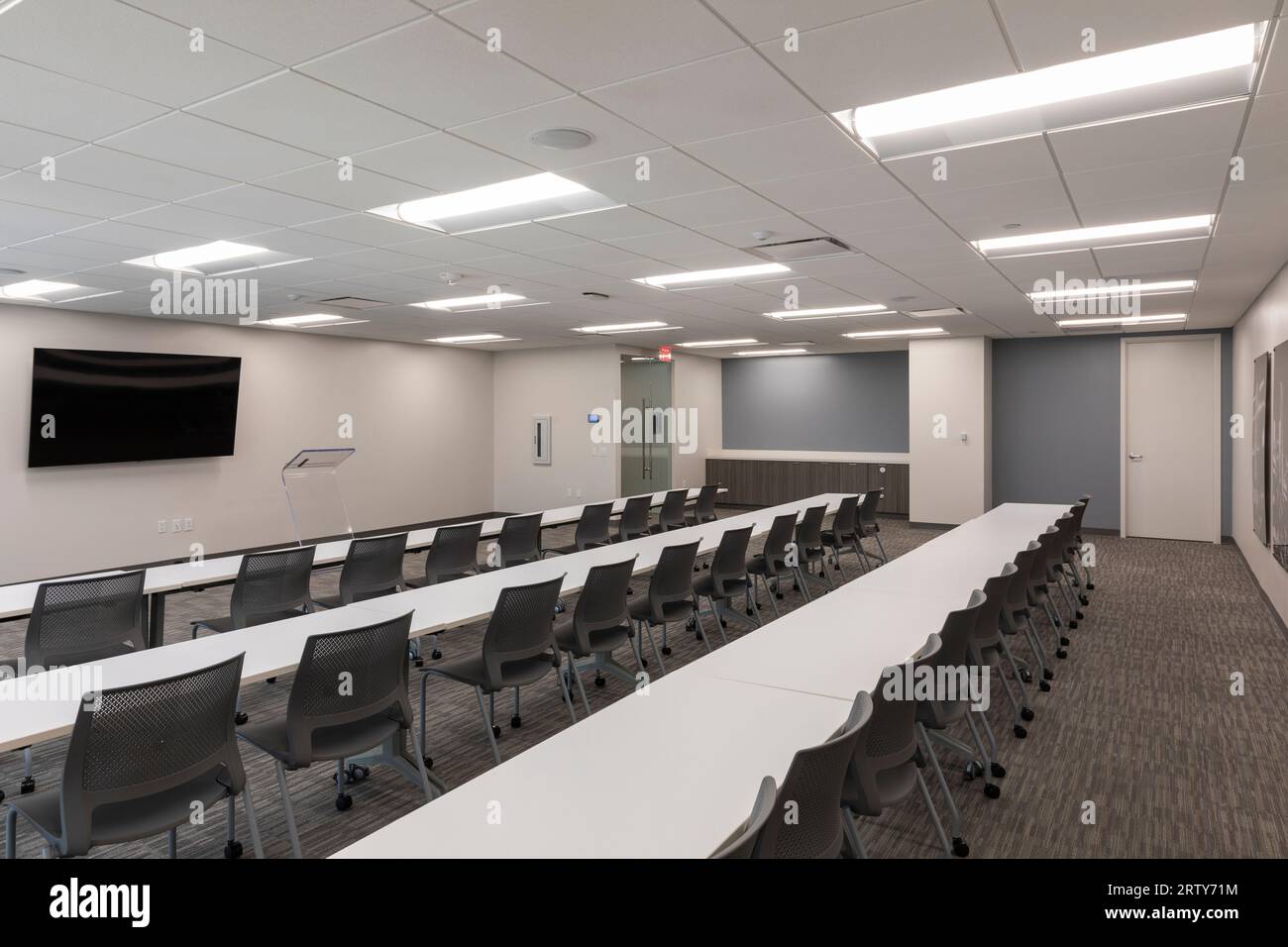 Tables and chairs in a row in a conference room Stock Photo - Alamy