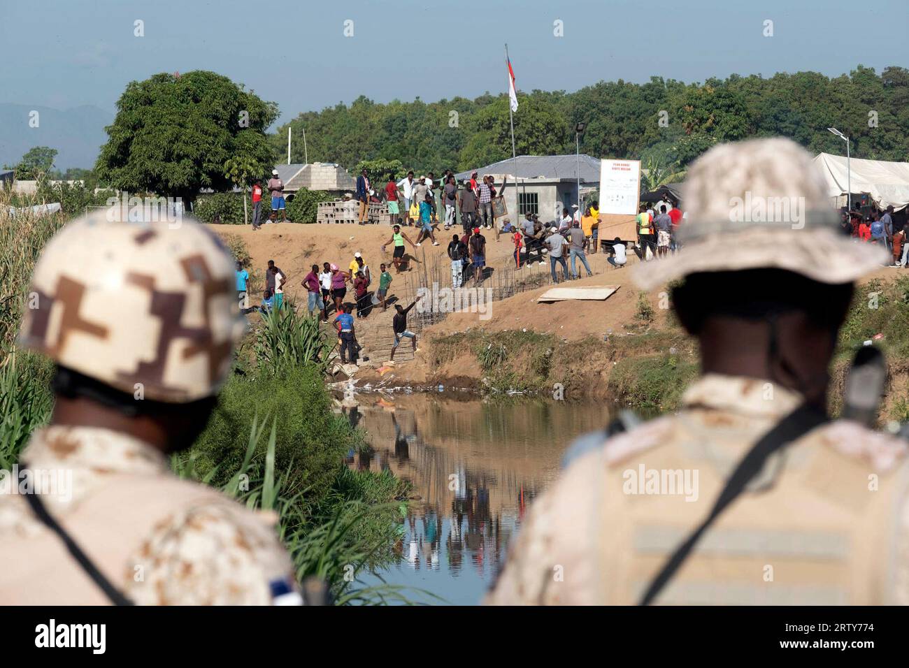 Dominican Republic soldiers stand on the bank of the Massacre River, a ...