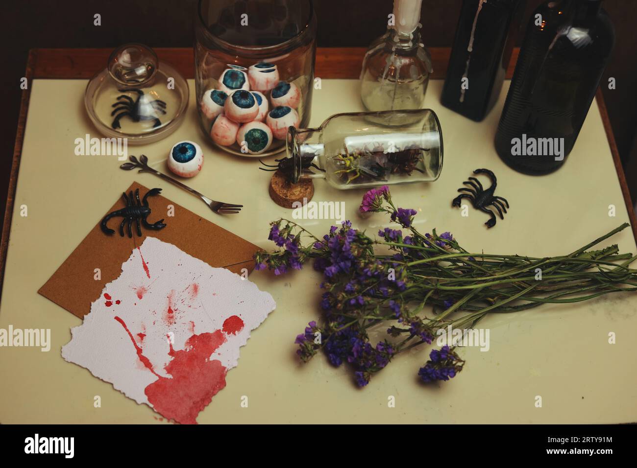 halloween still life with a blank bloody card, eyeballs, scorpions ...