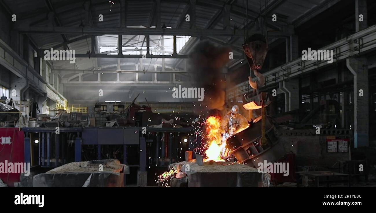 Hot molten metal being poured into a mold in a metallurgical plant ...